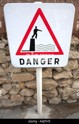 Danger sign next to the sea Stock Photo - Alamy