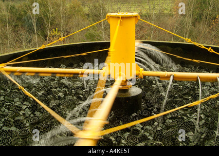 Sewage treatment plant works the rotating arm pours sewage over the ...