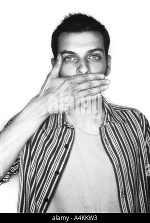 man with hand over mouth Stock Photo - Alamy