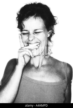 Black woman biting finger, portrait and studio with a model isolated on ...