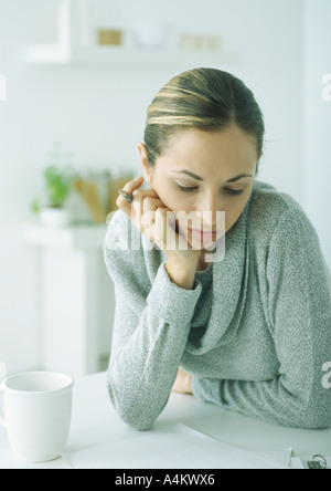 Woman leaning on a pen while thinking Stock Photo - Alamy