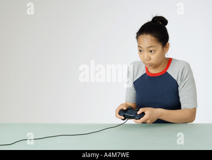 young Asian women playing video game using controller relaxing on ...