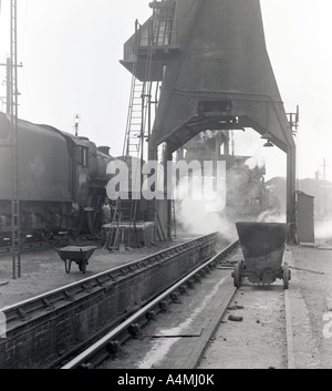 A view of an old steam locomotive coaling station obscured in the mist ...