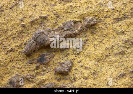 rocks embedded in yellow lava strata deposits in ancient lava flow ...