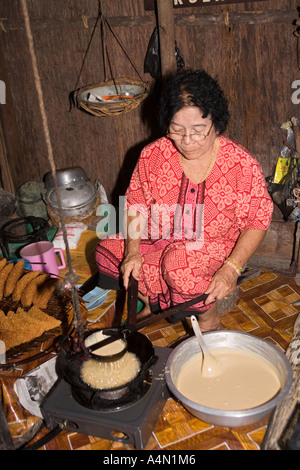 An Iban woman inside a traditional Iban longhouse near Lubok Antu ...