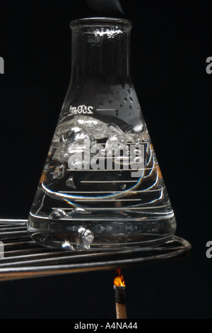 Water boiling in lab flask over bunsen burner Stock Photo - Alamy