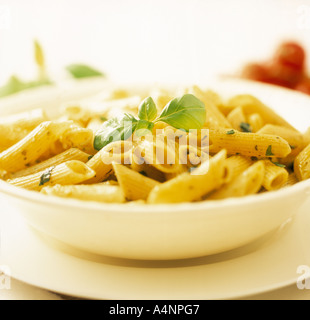 Penne pasta with pesto sauce and basil on wooden table Stock Photo - Alamy