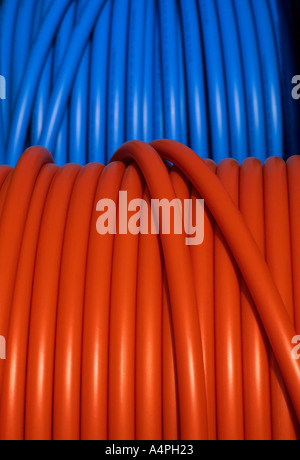 Red plastic pipe for fiber optic cable on trailer reel Stock Photo - Alamy
