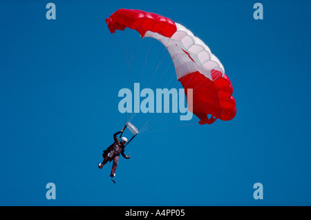 Parachutist with a white and red parachute against the blue sky Stock ...