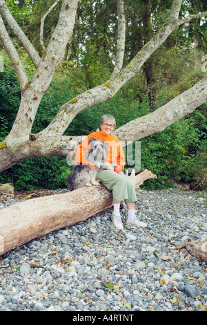 Portrait of smiling white woman with log house on background Stock ...