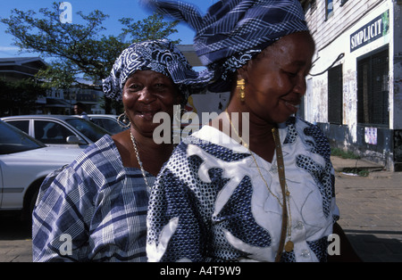 South America, Suriname, Paramaribo. Women walking down road at Fort ...