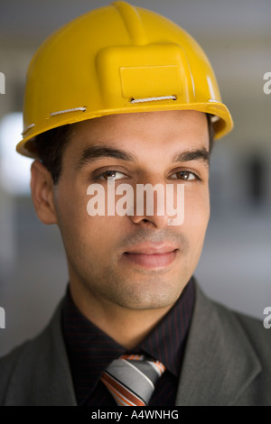 Man architect or businessman wearing hard hat and holding blueprints on ...