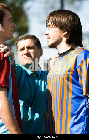 Soccer players arguing with referee on field Stock Photo - Alamy