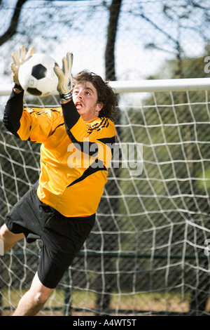 Male soccer goalie diving for ball Stock Photo - Alamy