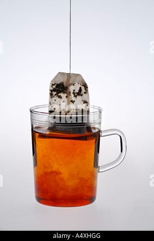 Hanging tea bags in a close-up image isolated over white background ...
