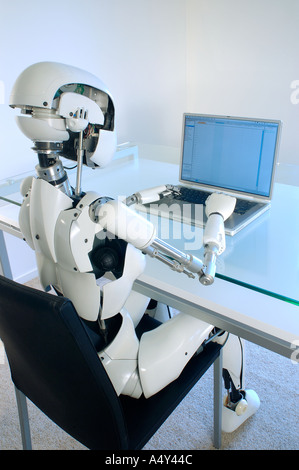 Female humanoid robot operating a laptop computer Stock Photo - Alamy