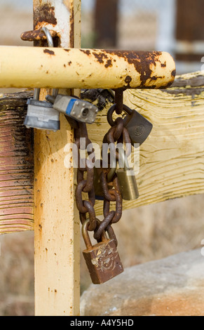 Multiple locks on a security gate. The removal of any one lock allows ...