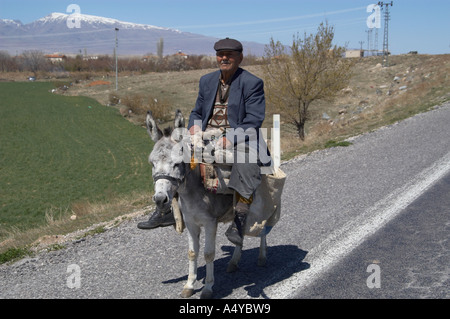 Turkish Man Riding donkey on road in Cappadocia region of Turkey Stock ...
