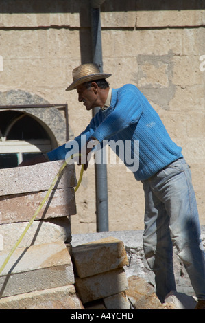 Stone masons at work building structure in Cappadocia Turkey Stock ...