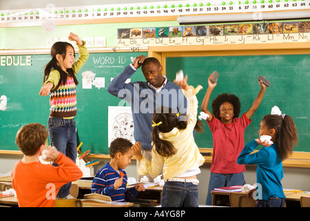 Students having paper fight in classroom Stock Photo - Alamy