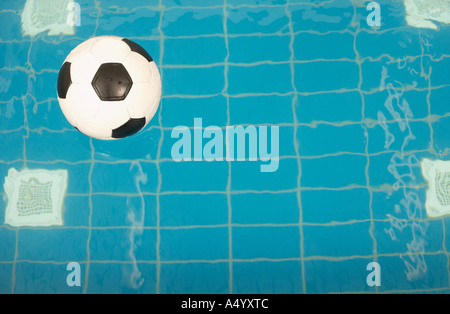 Soccer ball floating in the swimming pool Stock Photo - Alamy