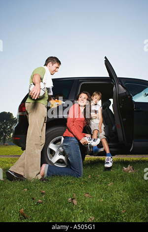 Family getting out of a car Stock Photo - Alamy