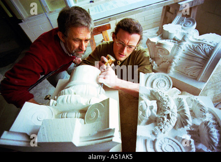 Training a young craftsman to become a stonemason Stock Photo - Alamy