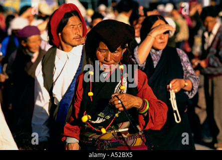 Women pilgrims walking around a sacred tree during a ritual in Rajgir ...