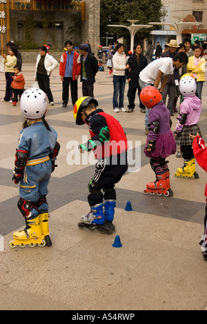 Kids learning to roller blade in the park Kunming China Stock Photo - Alamy