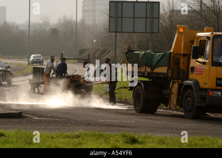 Road construction gang of workers making lots of heat and steam Stock ...