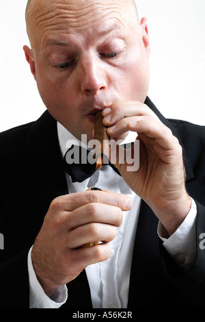 Front view of a man lighting a cigar Stock Photo - Alamy