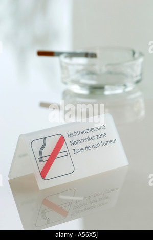 Ash tray with cigarettes on color wooden background Stock Photo - Alamy