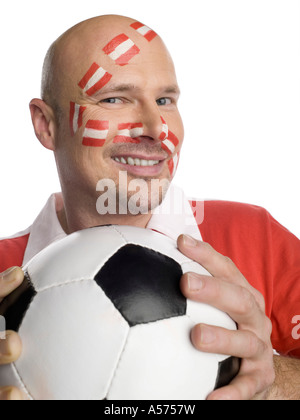 A fan with Austria flag face paint waits for the start of the World Cup ...
