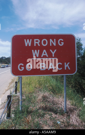Wrong Way Go Back traffic warning sign at the exit to a tunnel in ...