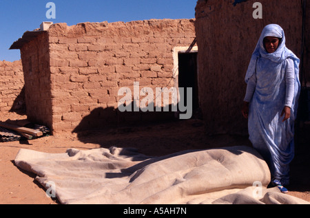 Woman in Bedouin clothes standing on dune in desert. Sahara desert ...