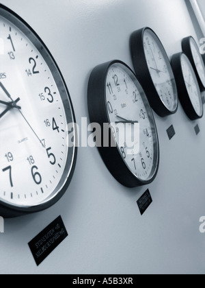 Row of clocks displaying different time zones Stock Photo - Alamy