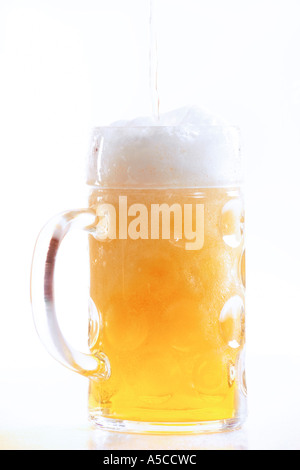 Beer pouring into mug Stock Photo - Alamy