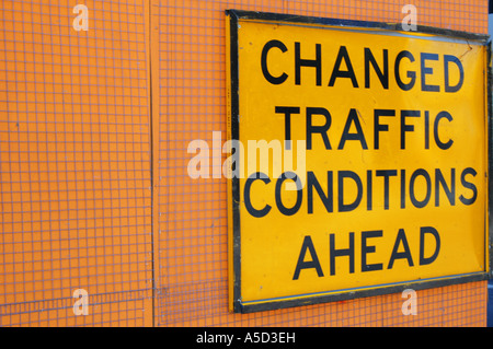 Changed traffic conditions warning sign on fence at a construction site ...