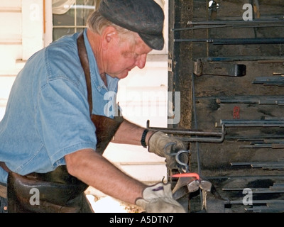 iron worker craftsman demonstrates old tools from the California Gold ...