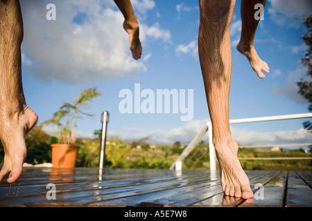 Two Men Running and Jumping into Swimming Pool Stock Photo - Alamy