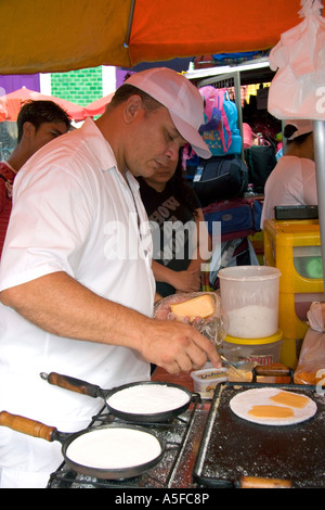 A man cooking tapioca into a kind of pancake in Manaus Brazil Stock ...