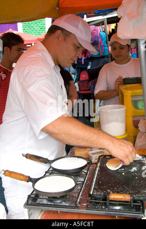 A man cooking tapioca into a kind of pancake in Manaus Brazil Stock ...