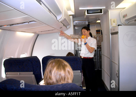 stewardess showing how to use the oxygen-mask during the safety ...