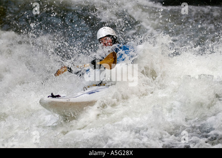 Kayaker paddles through class five rapid at a whitewater race Stock ...