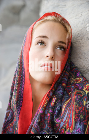 Portrait of pretty Caucasian woman draped over sofa by window looking ...