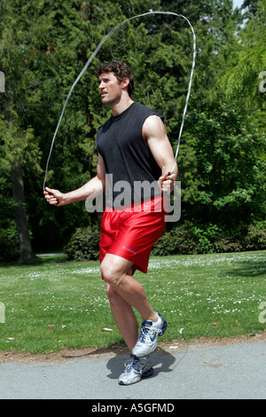 Muscular black man skipping rope. Portrait of muscular young man ...