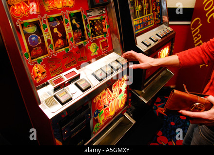 Elderly woman playing a slot machine in the casino of the Paris Hotel ...