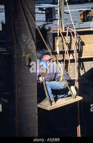 Ironworker connector on steel beam aligning pieces of steel frame for ...