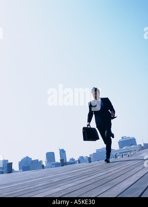 Asian Man running on a walkway Stock Photo - Alamy