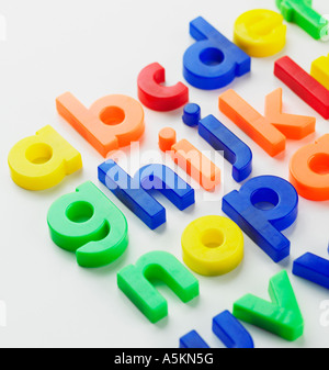 Close-up view of alphabet magnets scattered over white background Stock ...
